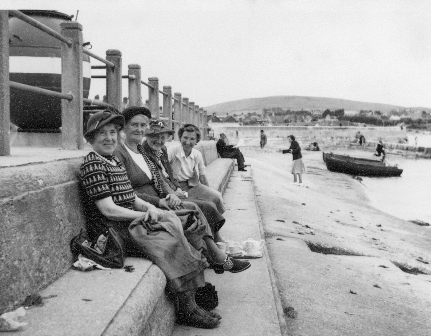 Family sat near the Stone Quay | Swanage gallery